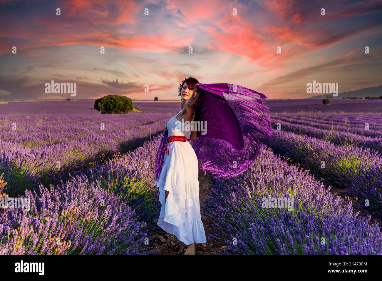 Woman looking at the camera while posing outdoors in a colorful ...