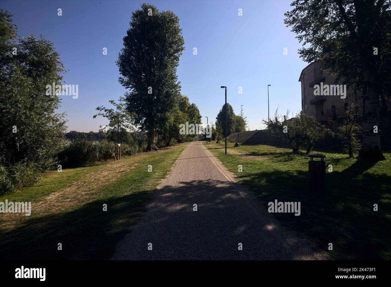 Gravel path in a park by the lakeshore at sunset Stock Photo - Alamy