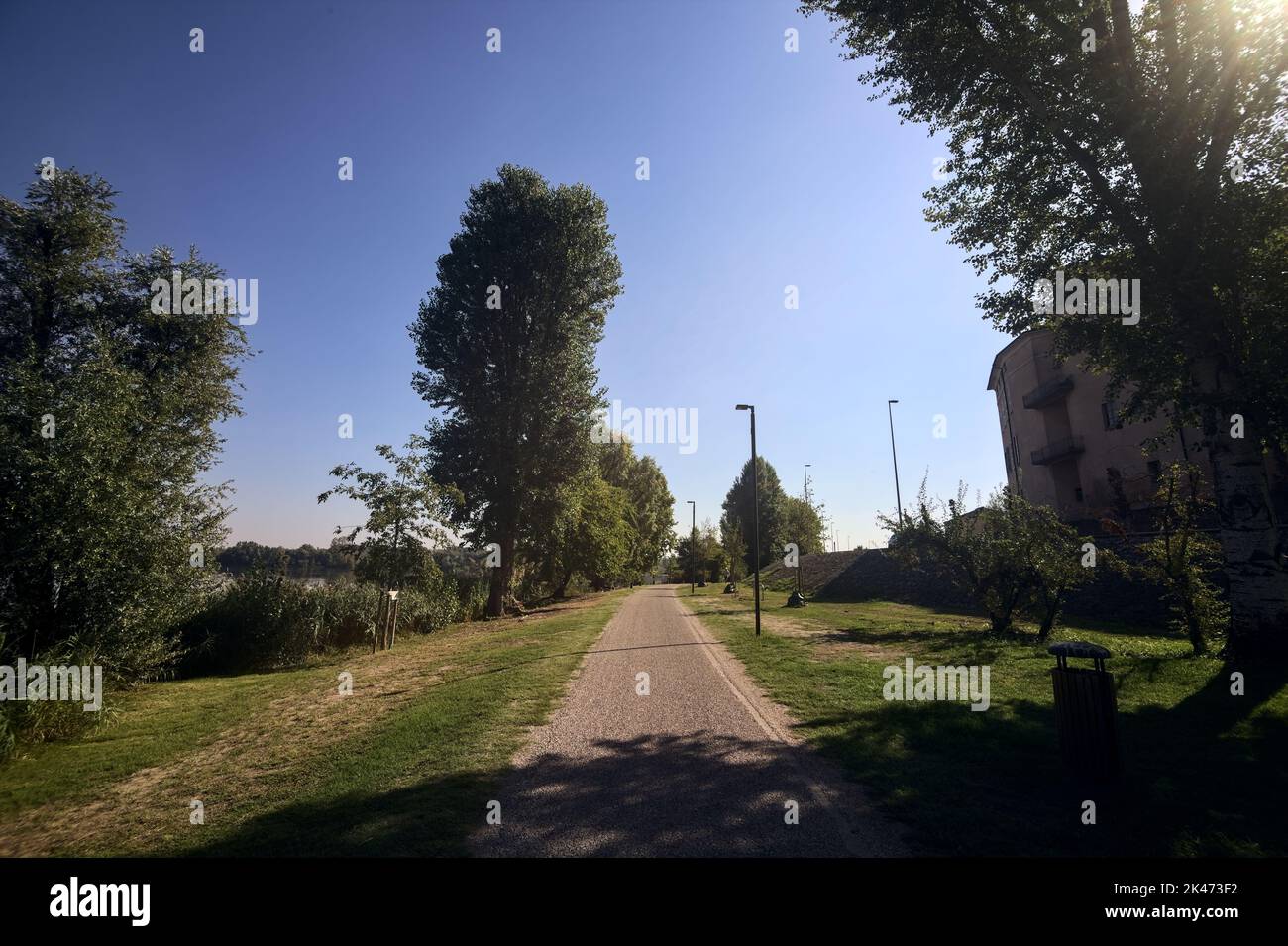 Gravel path in a park by the lakeshore at sunset Stock Photo - Alamy