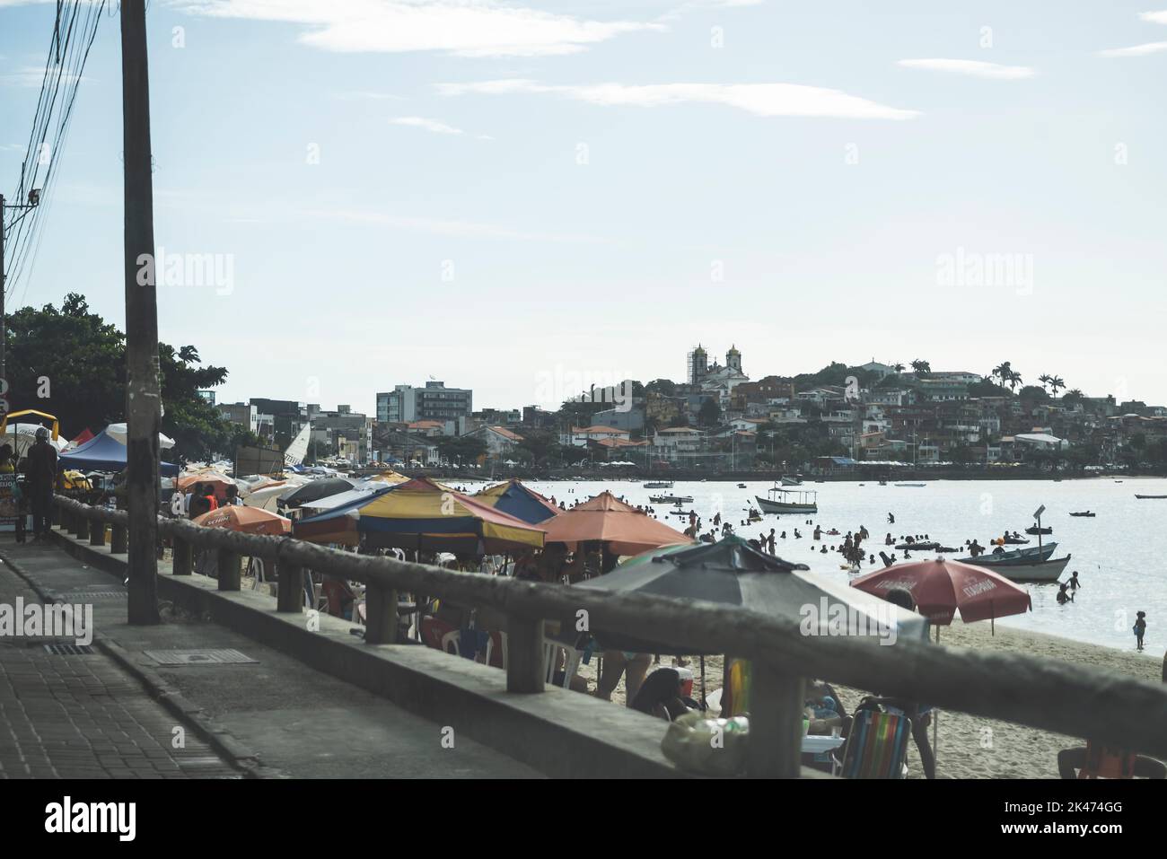 Bathers and tourists are sunbathing on the beach on a beautiful bright ...