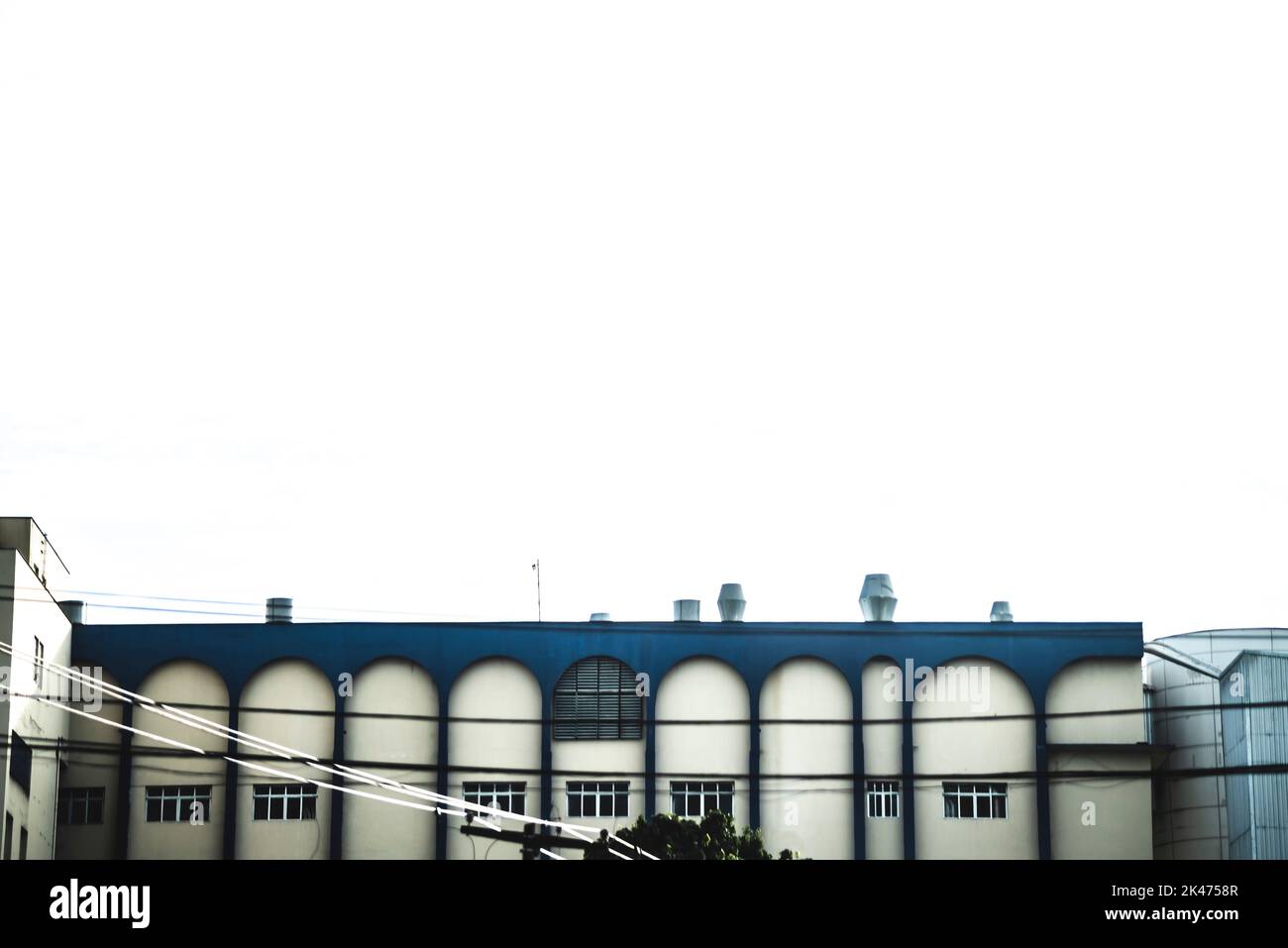 Facade of a building with rounded windows of light and blue color. City ...