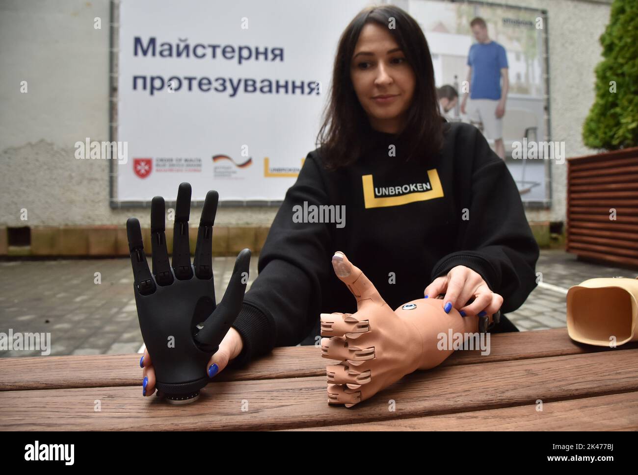 A woman demonstrates modern bionic hand prostheses, which will be ...