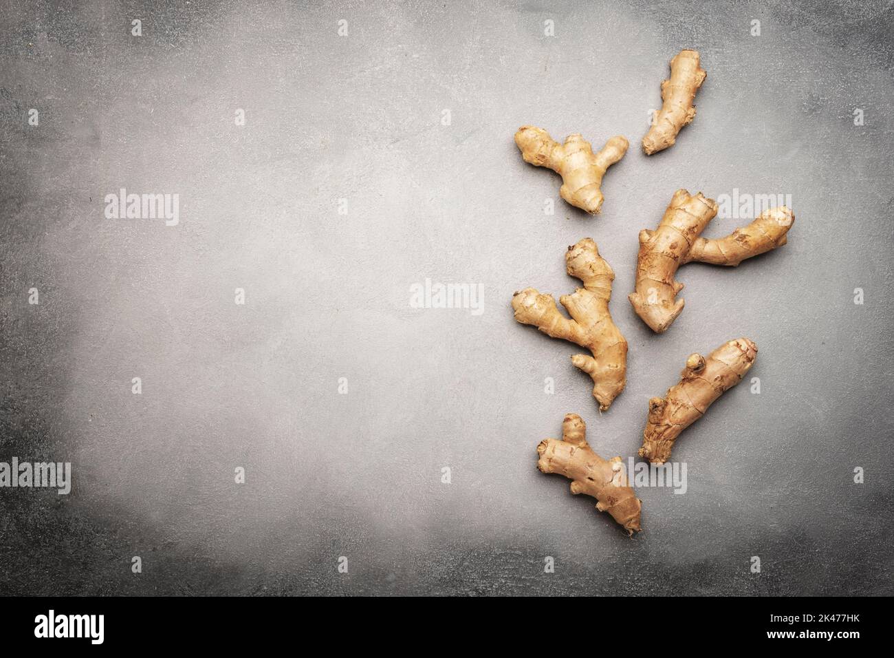 Fresh ginger root. Gray kitchen table background, top view Stock Photo ...