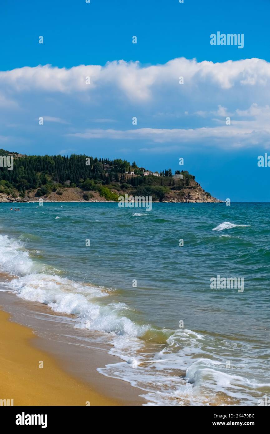 Beach with golden sand, clouds and waves in Kavala in Greece Stock ...