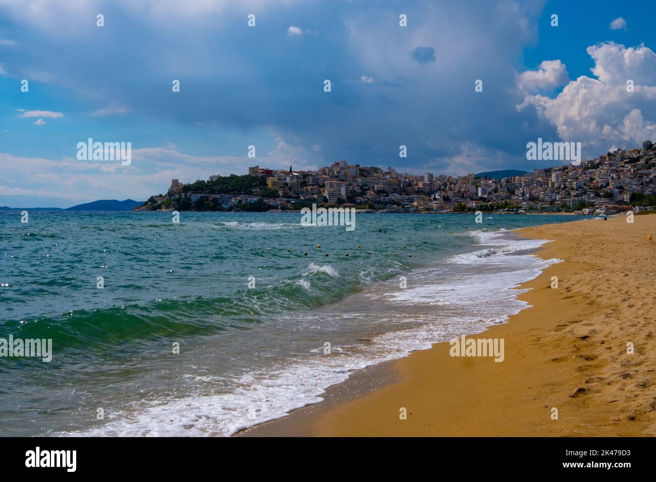 Beach with golden sand, clouds and waves in Kavala in Greece Stock ...