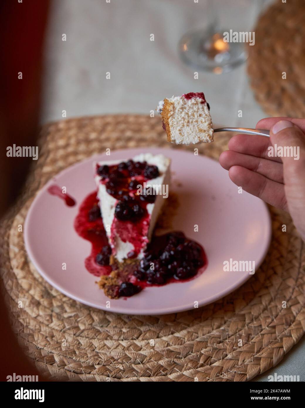 Unrecognizable man eating delicious homemade cheesecake served as ...