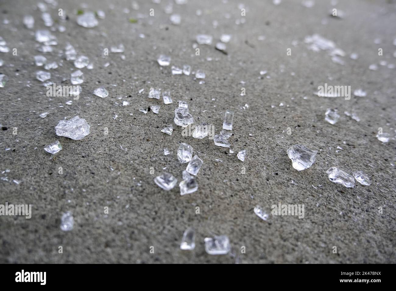 Broken glass on ground, danger and vandalism Stock Photo - Alamy