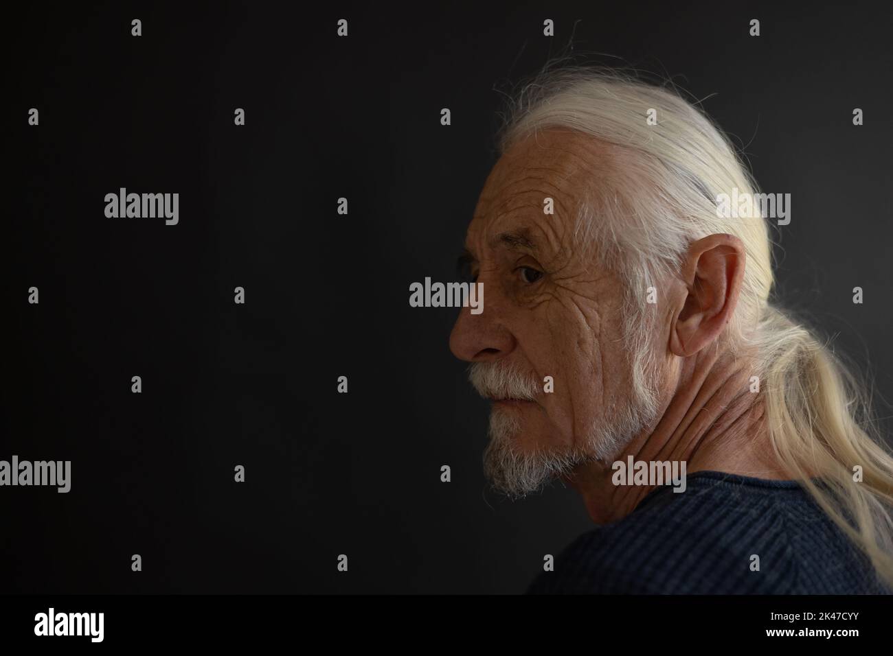 Low key studio portrait of beautiful old man - rocker fan - looking ...
