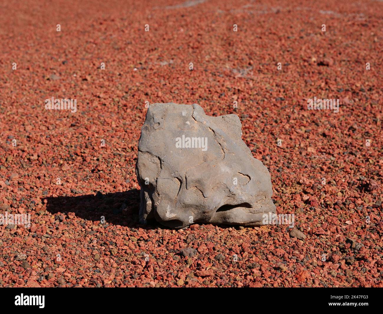 Stone on red ferruginous volcanic rock Stock Photo - Alamy