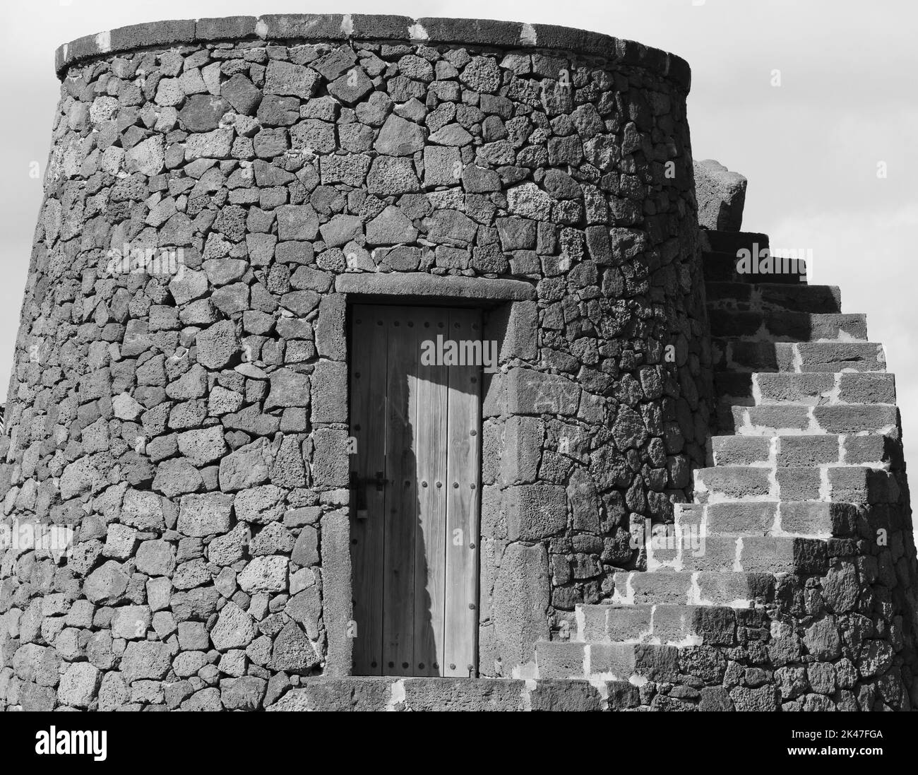 Old tower with wooden door and stairway built of tufa stone Stock Photo ...