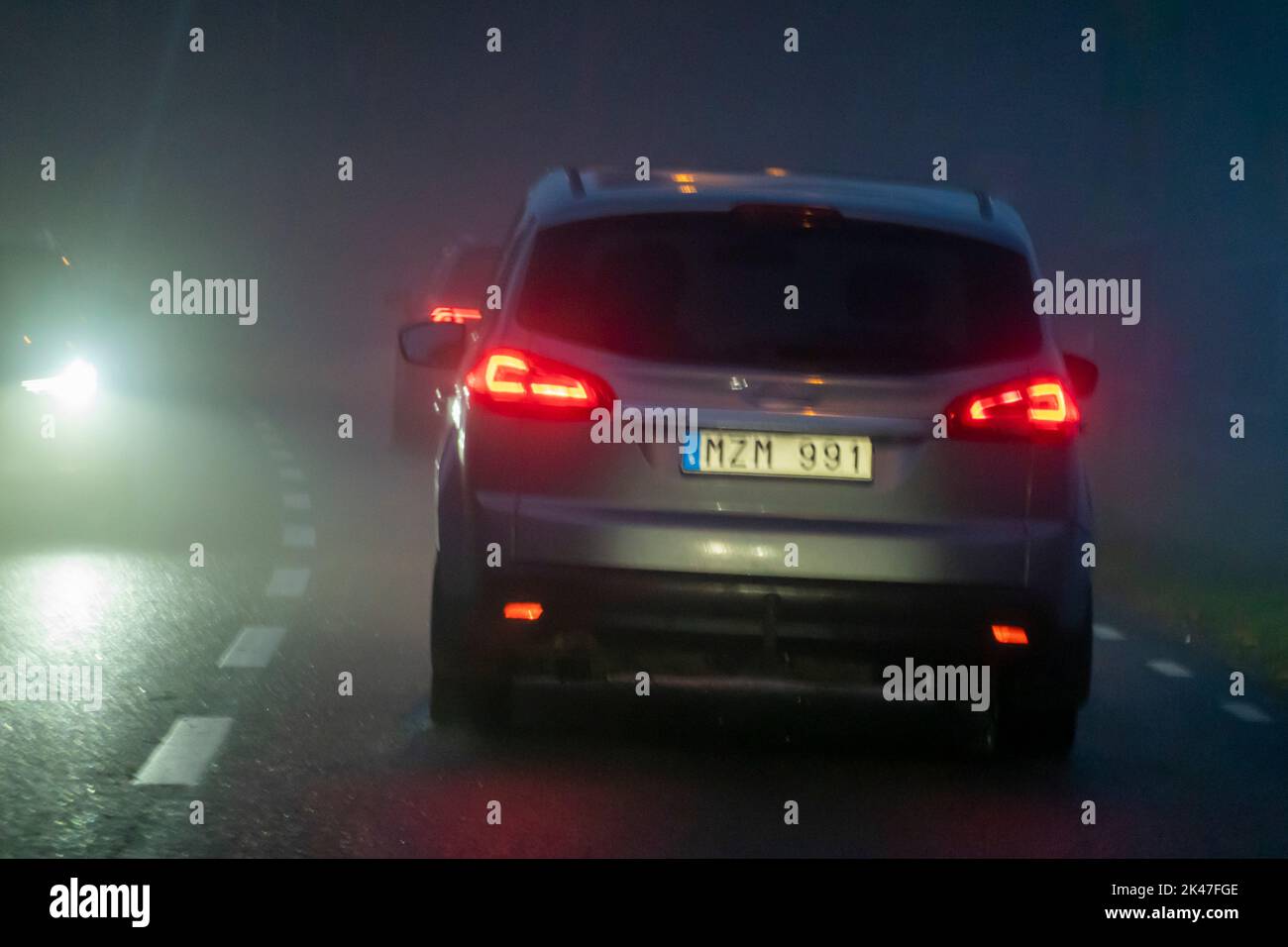 Car driving in fog at night Stock Photo - Alamy