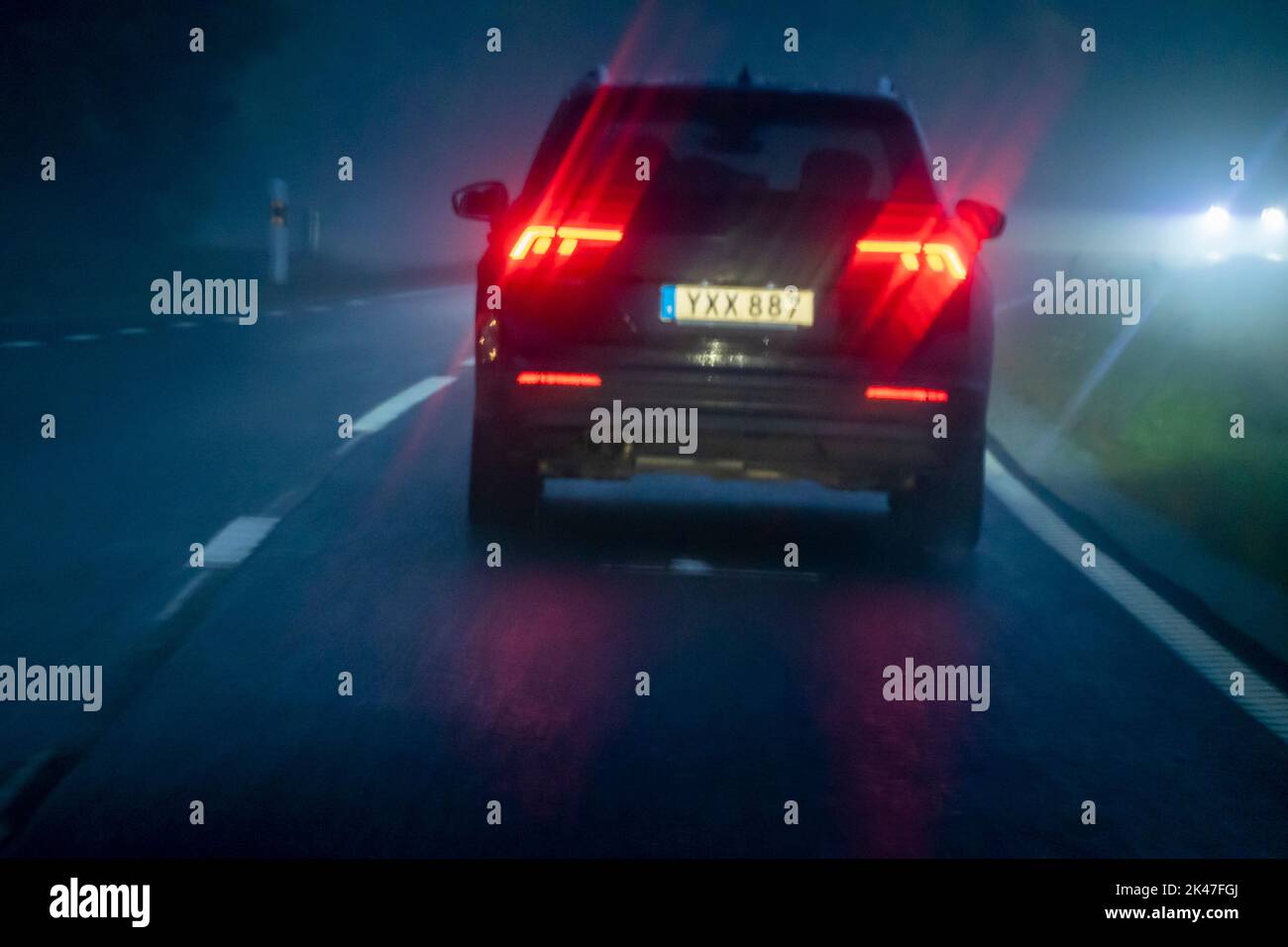 Car driving in fog at night Stock Photo - Alamy