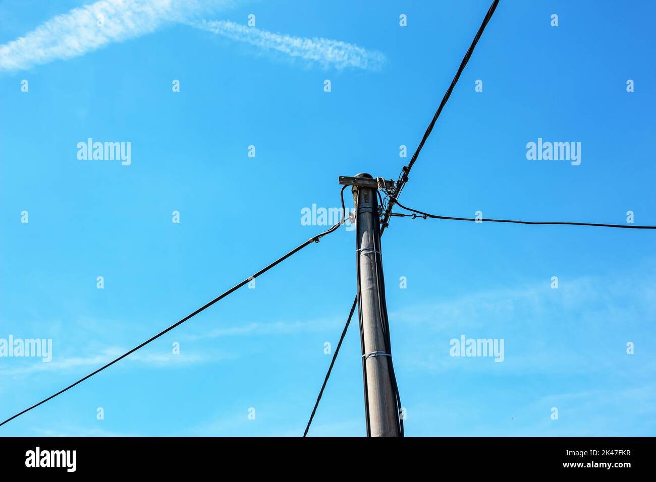 Electric pole power lines outgoing electric wires againts on cloud blue ...