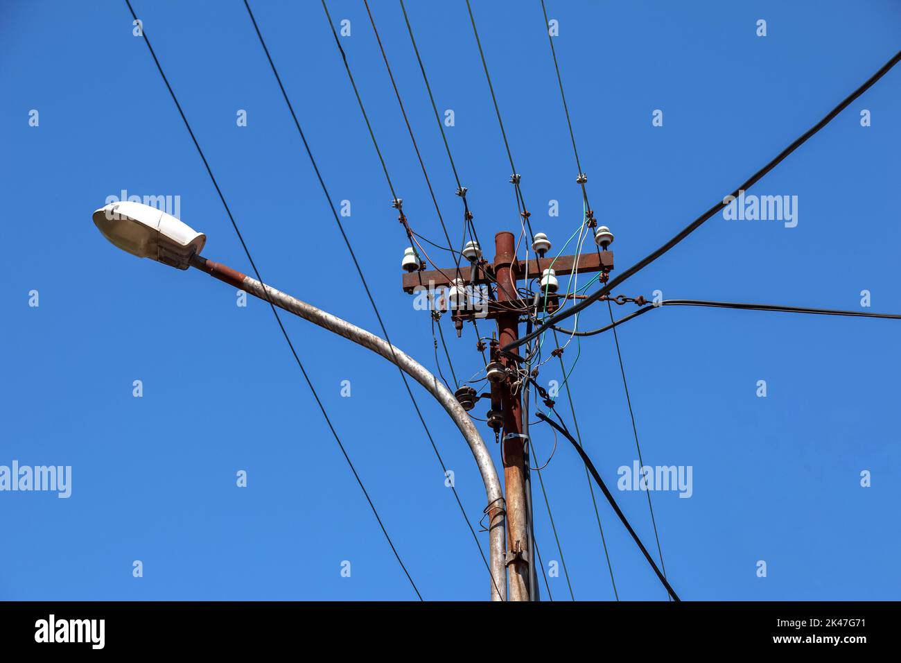 Electric pole power lines outgoing electric wires againts on cloud blue ...