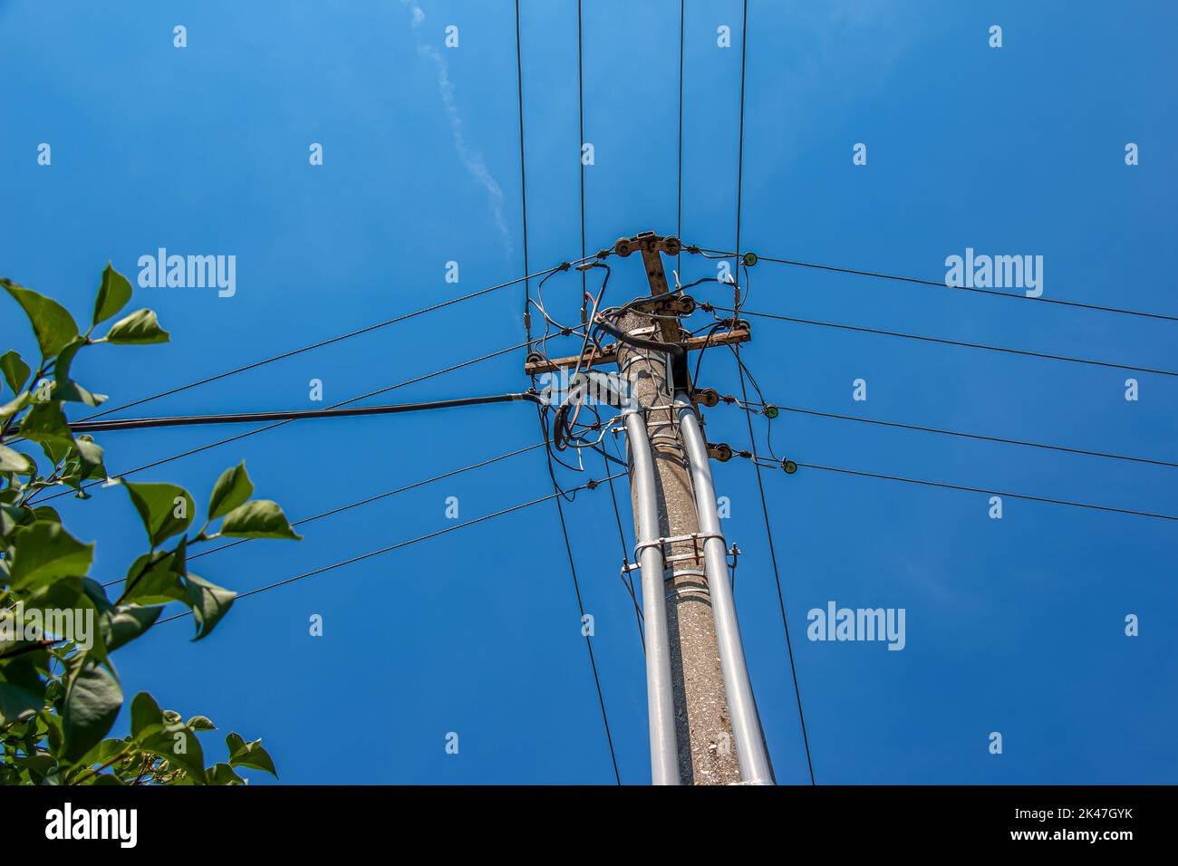 Electric pole power lines outgoing electric wires againts on cloud blue ...