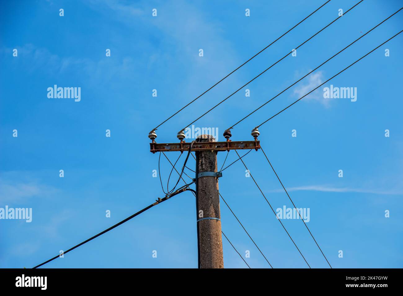 Electric pole power lines outgoing electric wires againts on cloud blue ...