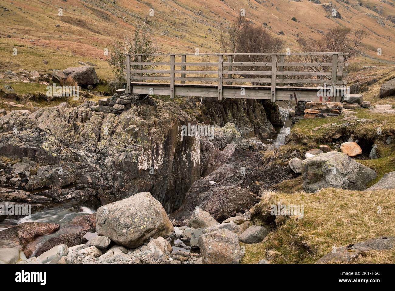 Wooden footbridge over the Langstrath Beck in the Langstrath Valley ...