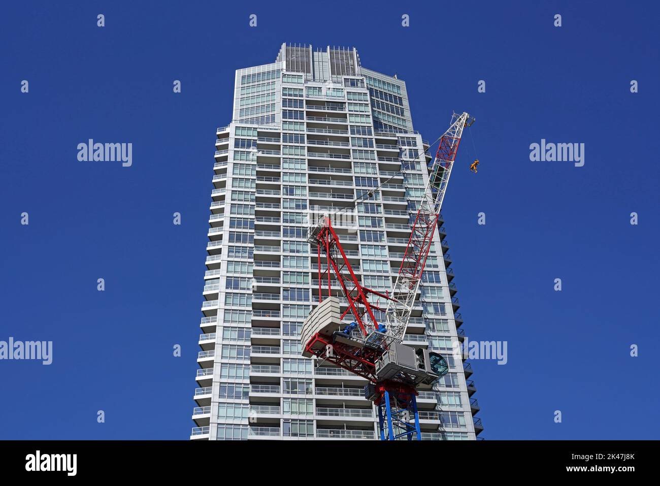 Recently completed high rise apartment building beside crane to ...