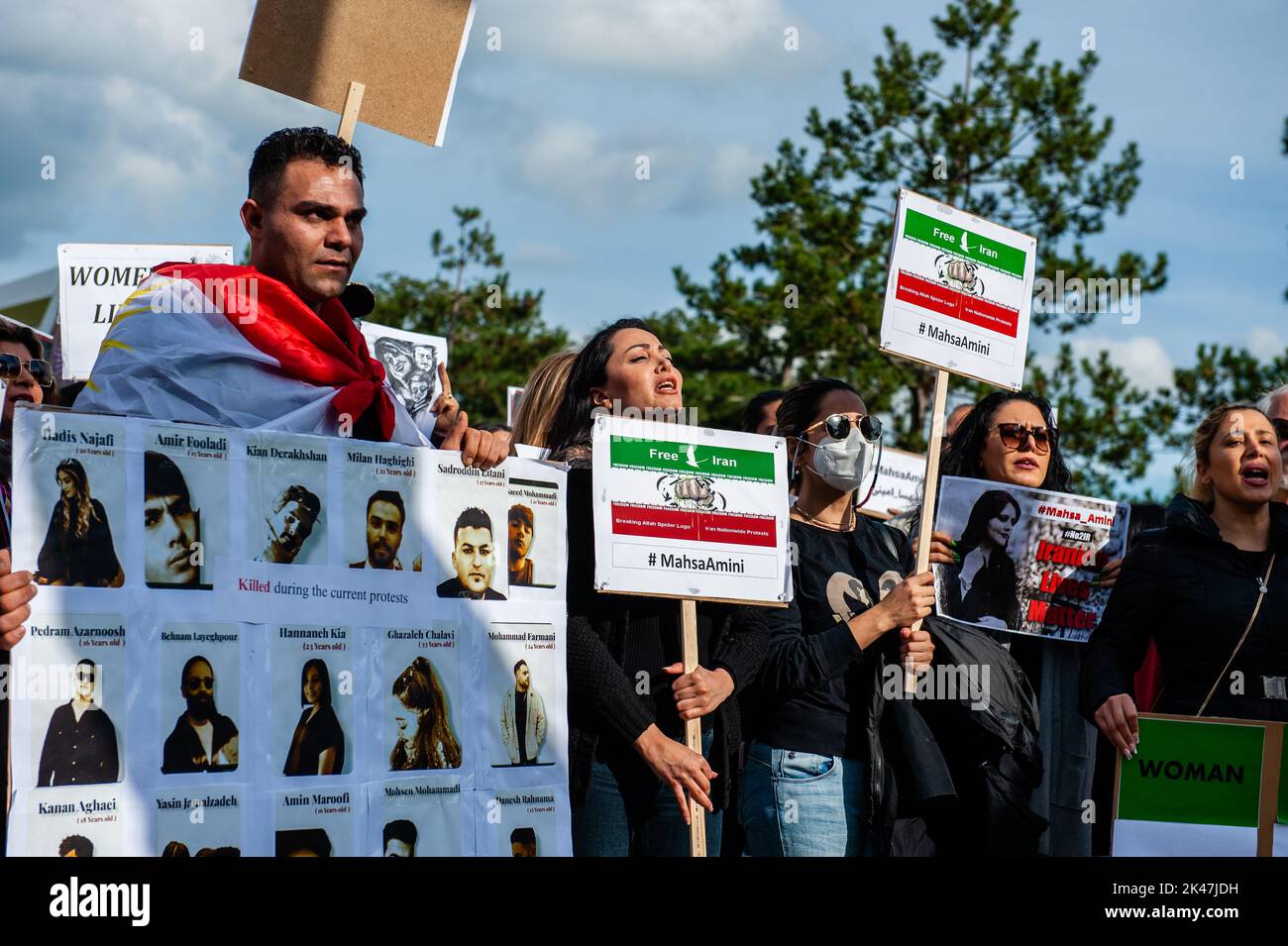 Iranian people are seen holding placards in support of the freedom of ...