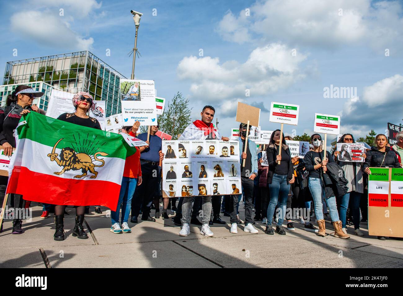 Iranian people are seen holding Iranian flags and placards in support ...
