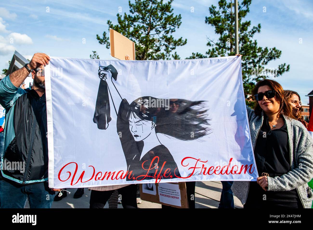 A man and and Iranian woman are seen holding a big banner in support of ...