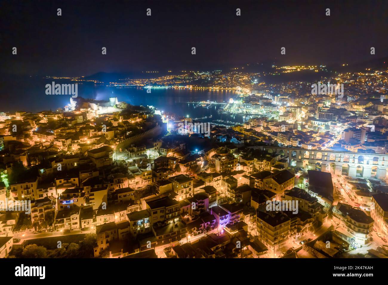 Aerial view the city of Kavala at night, in northern Greece, ancient ...