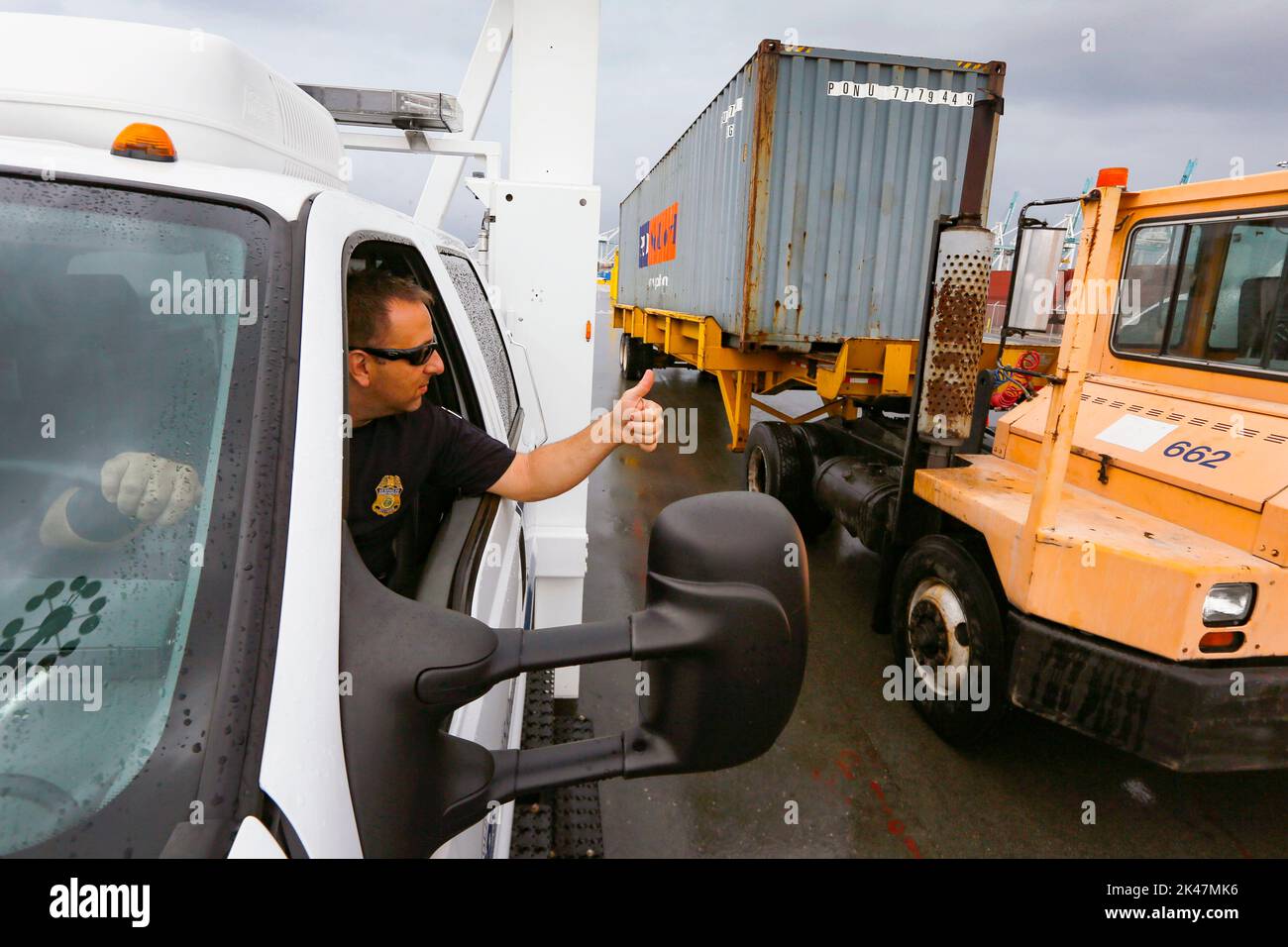 A U.S. Customs and Border Protection officer gives the thumbs-up to the ...