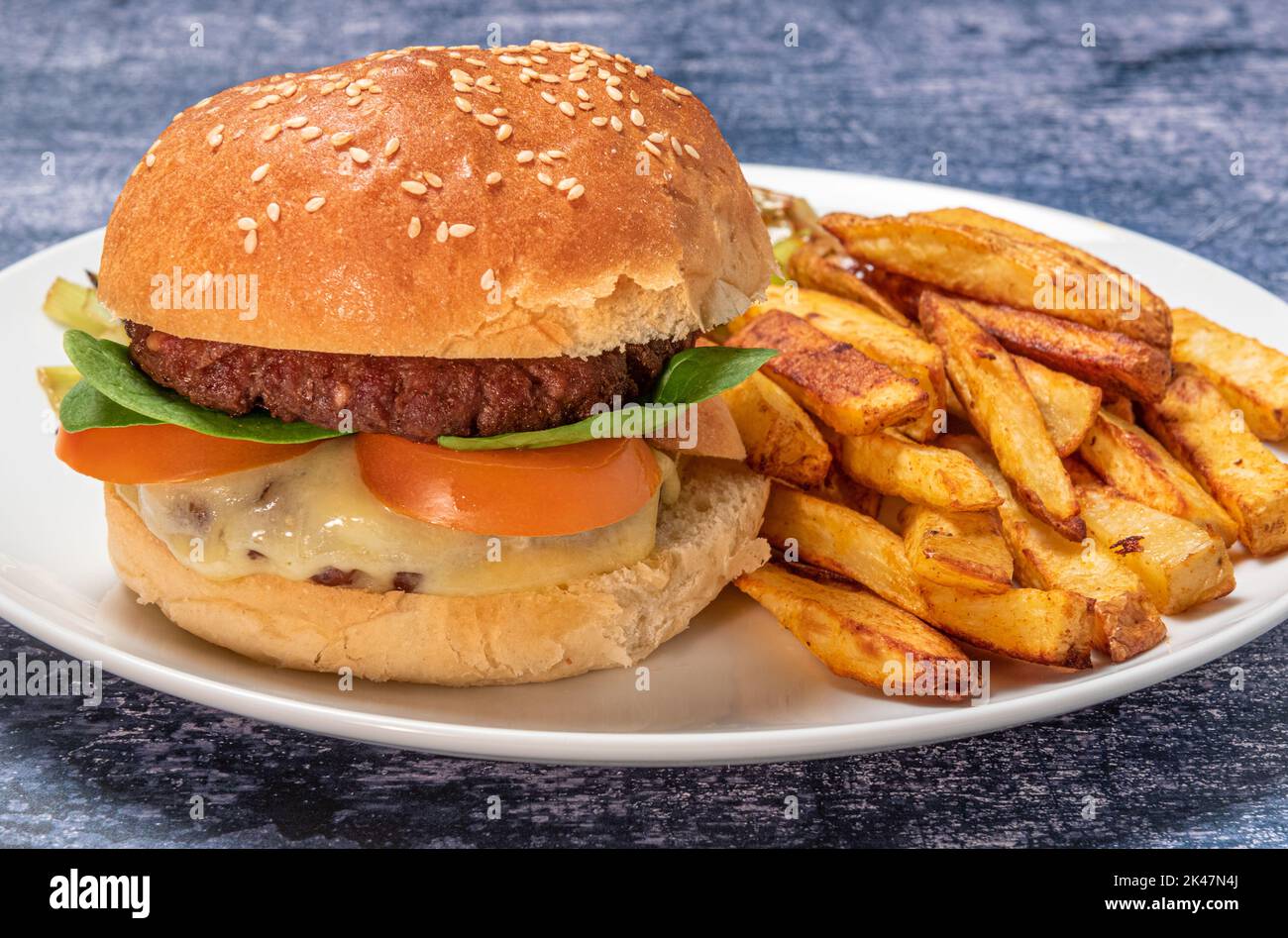 Beefburger in brioche burger bun with salad and chips Stock Photo - Alamy