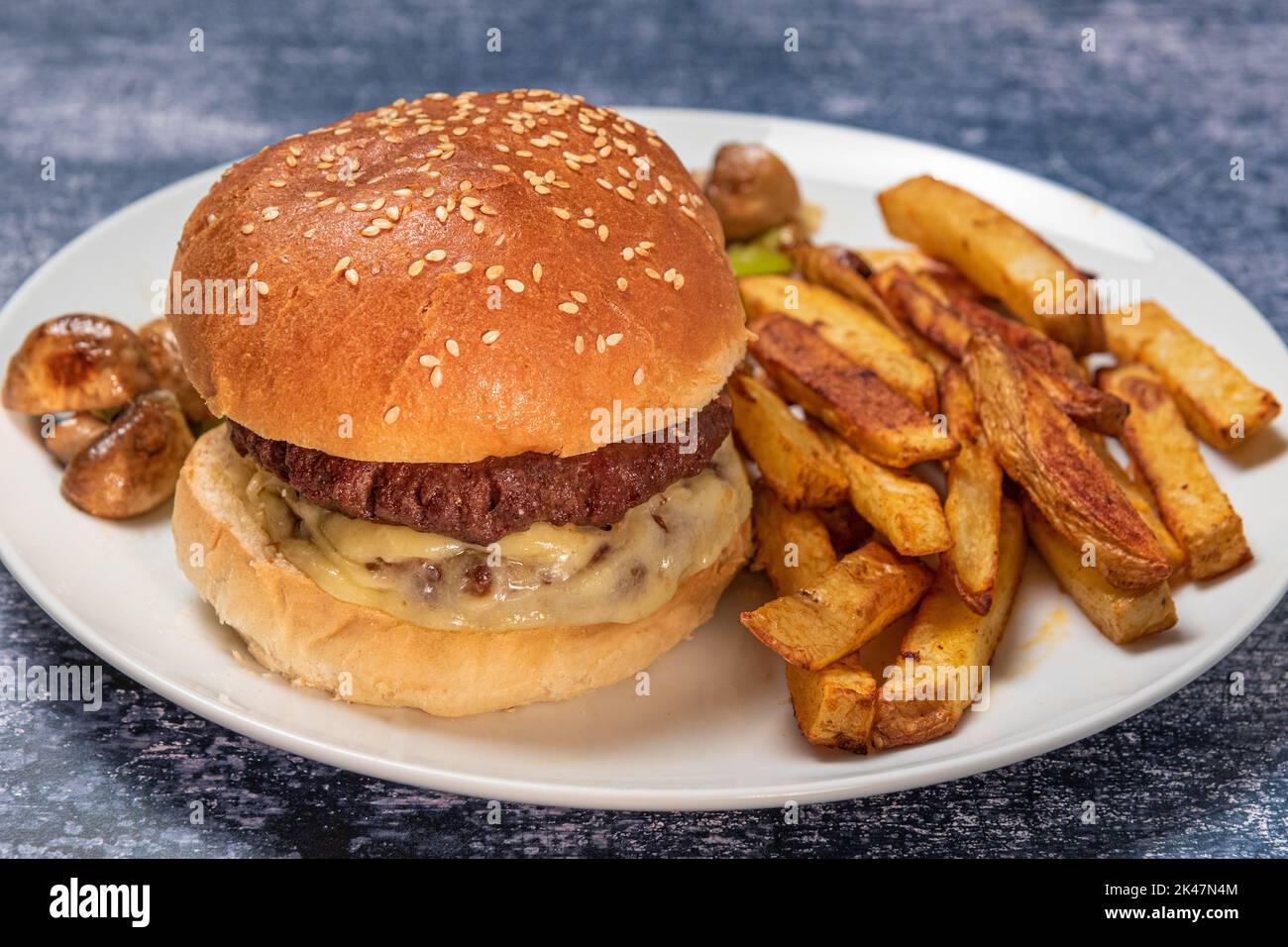 Beefburger in brioche burger bun with home made skin on chips Stock ...