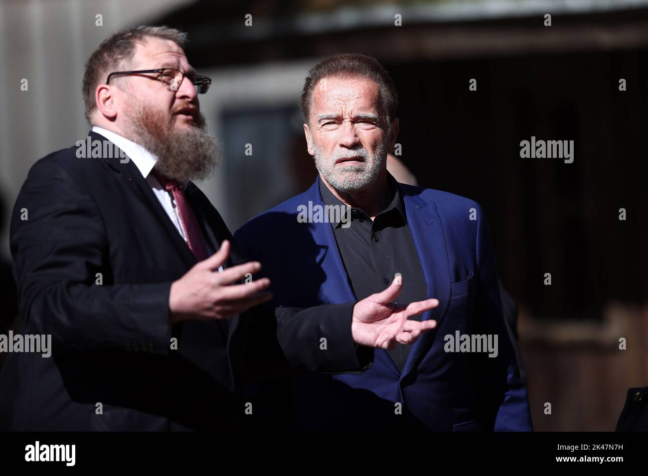 Actor Arnold Schwarzenegger speaks with Simon Bergson, president of ...