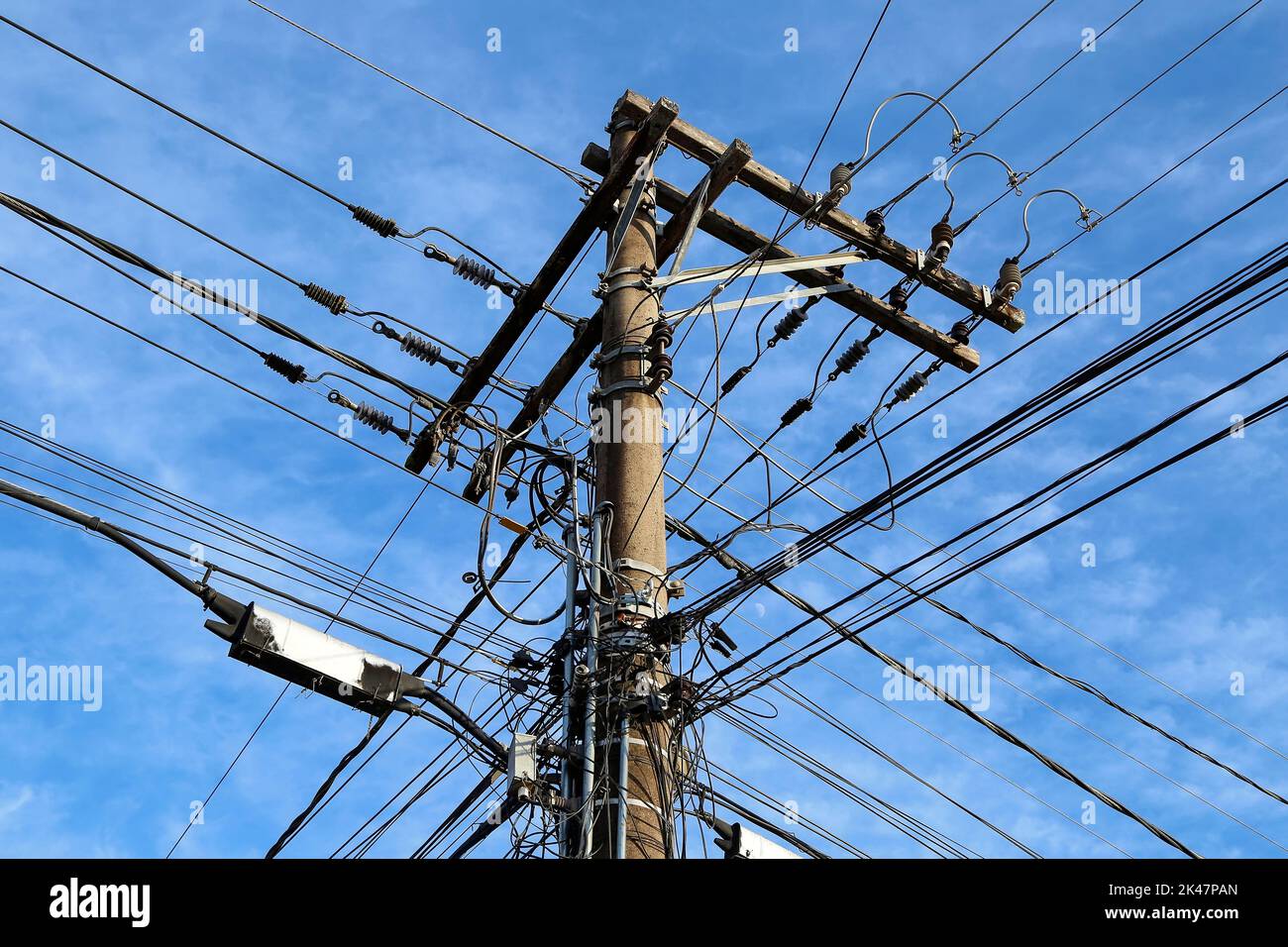 concrete pole with electrical power, telephony and fiber optic cabling ...