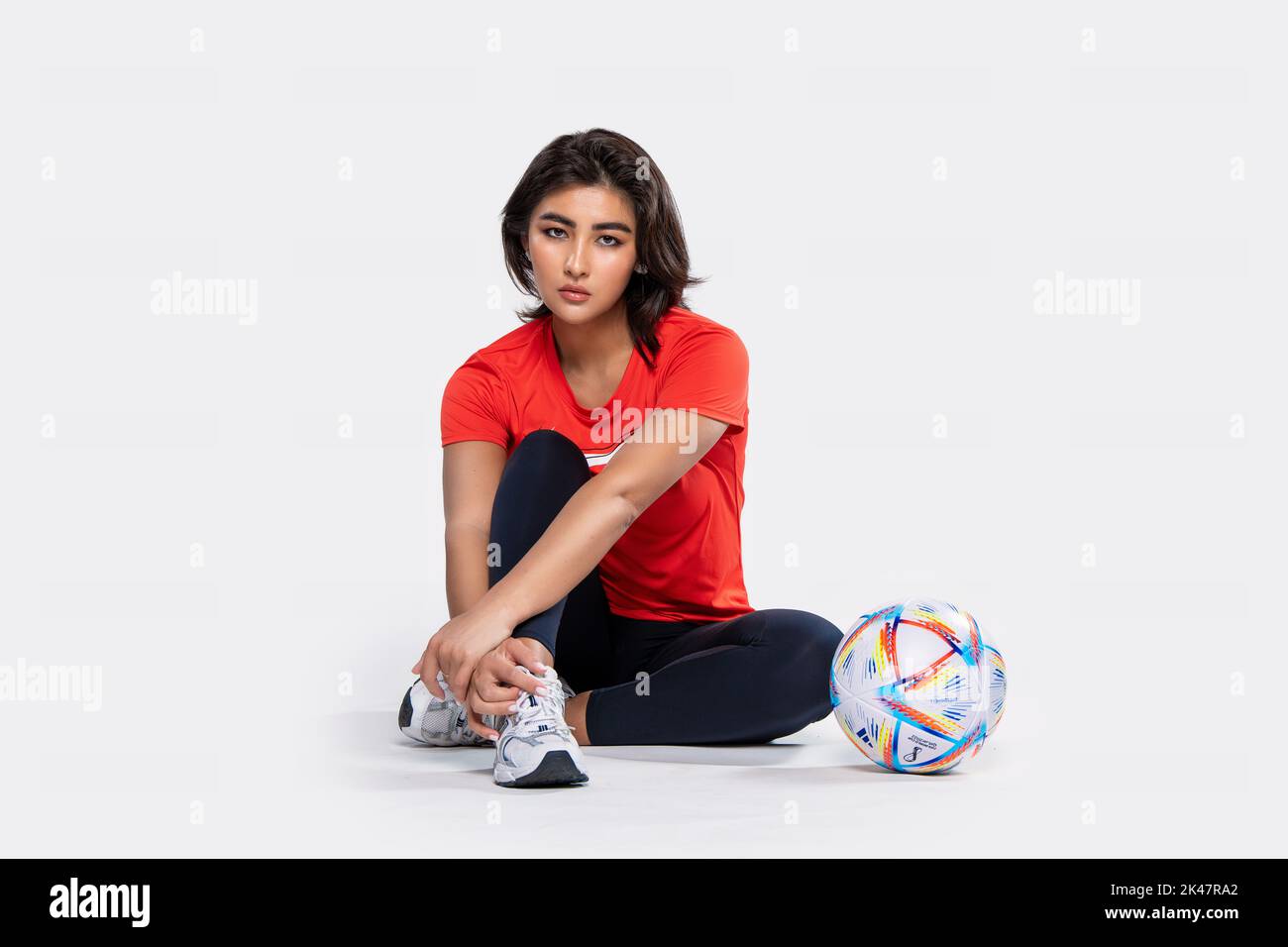 Young football player with FIFA Qatar Match ball Al Rihla on isolated ...