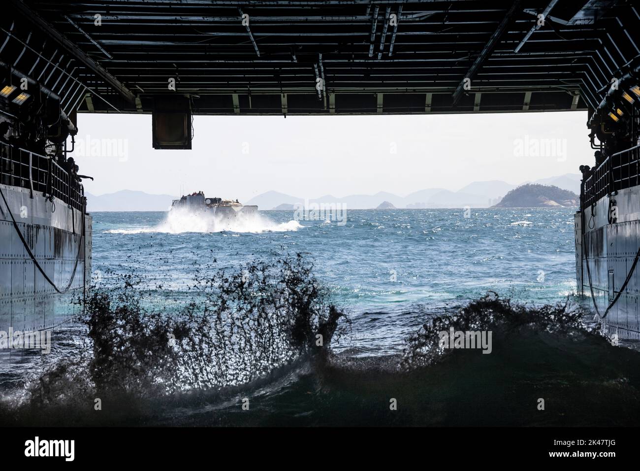 U.S. Navy Landing Craft, Utility 1663 approaches the well deck of the ...