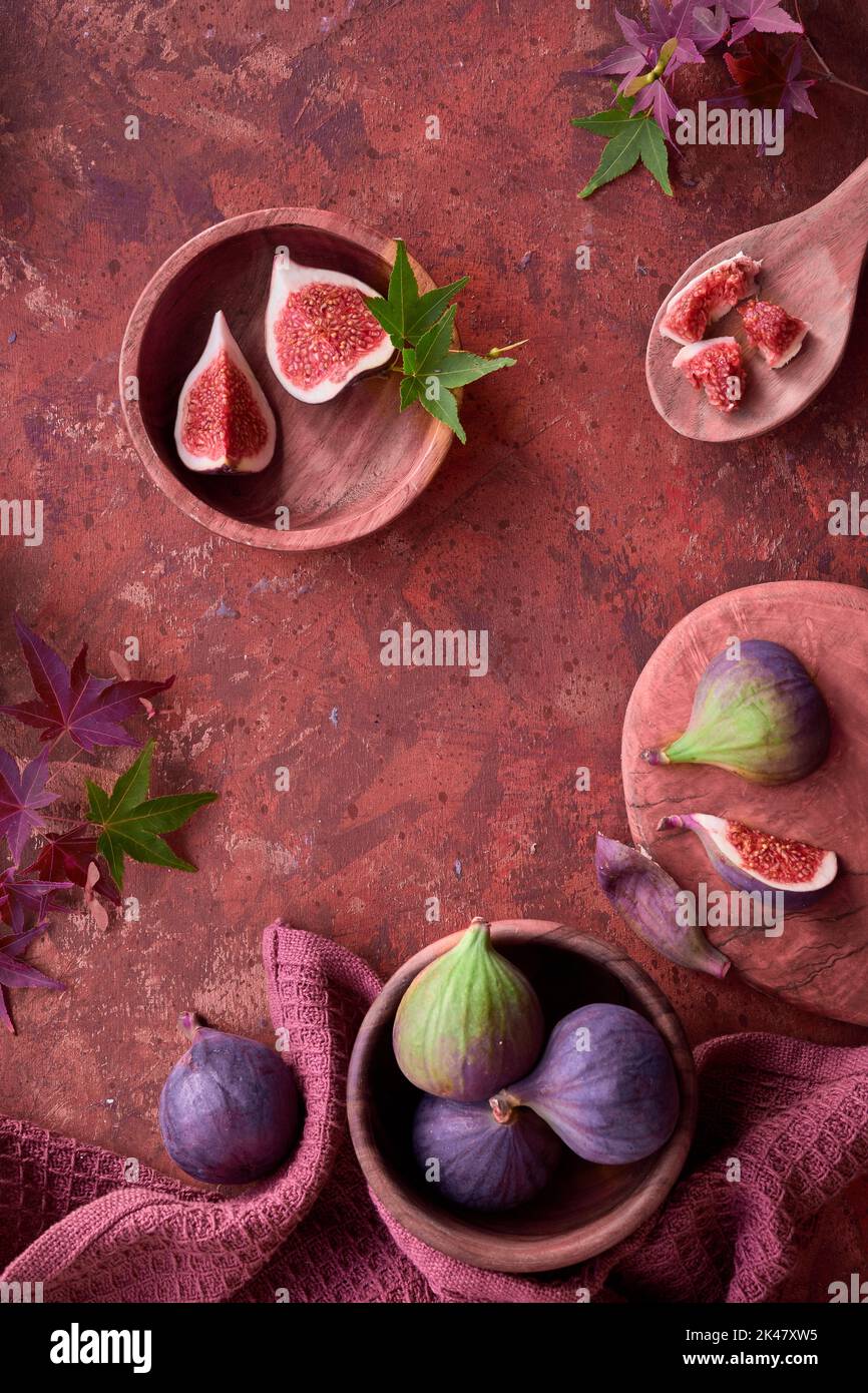 Fresh halved fig fruits and dry euvalyptus and cala lily flowers ...