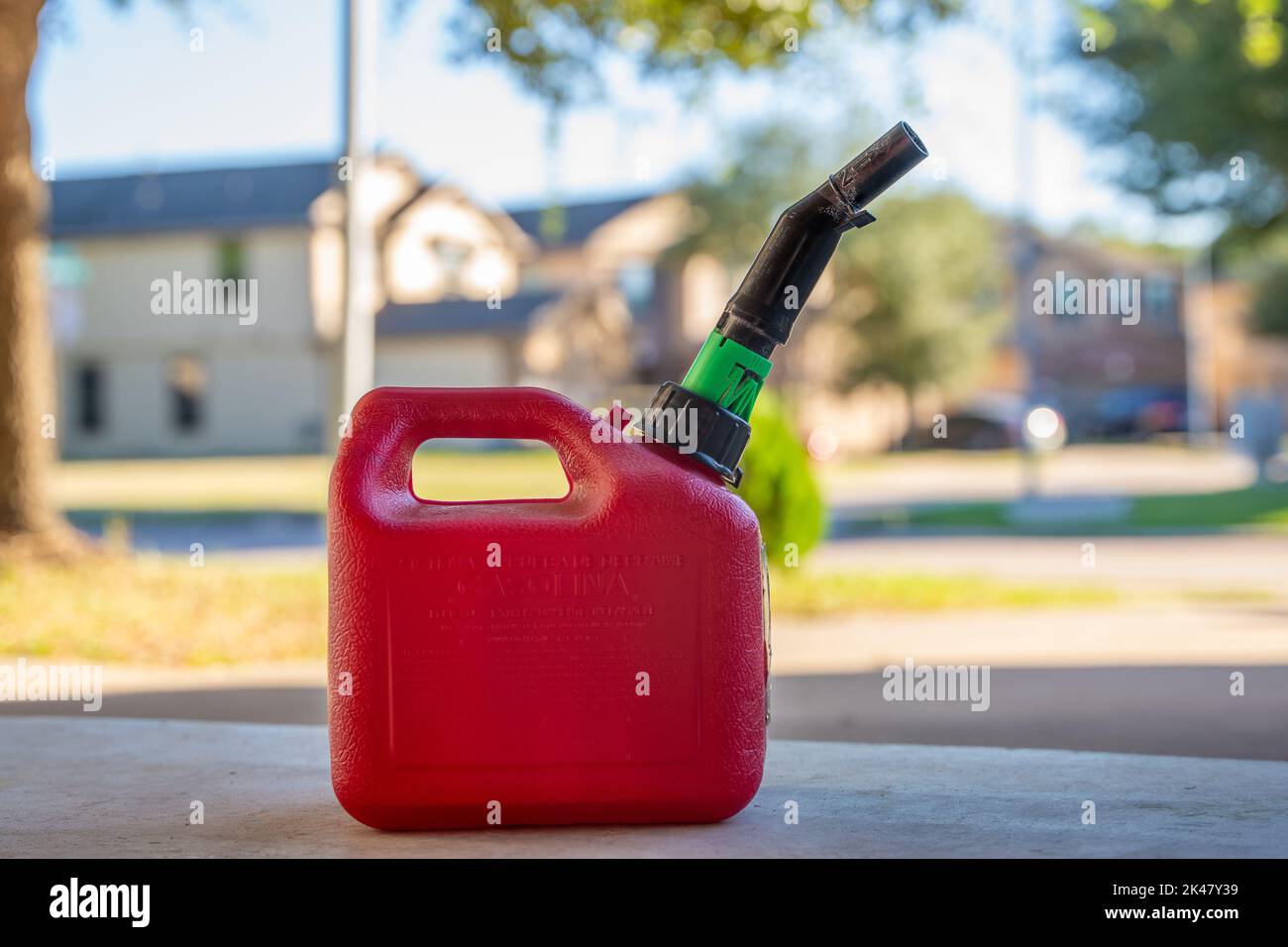 red gas container outside with green cap Stock Photo - Alamy