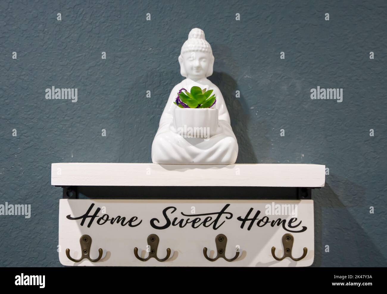 buddha key hanging spot with home sweet home Stock Photo - Alamy