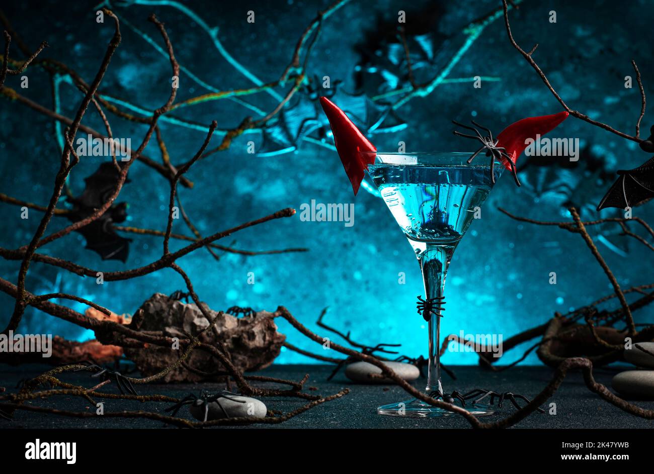 Halloween alcoholic cocktail evil martini on scary dark blue background ...