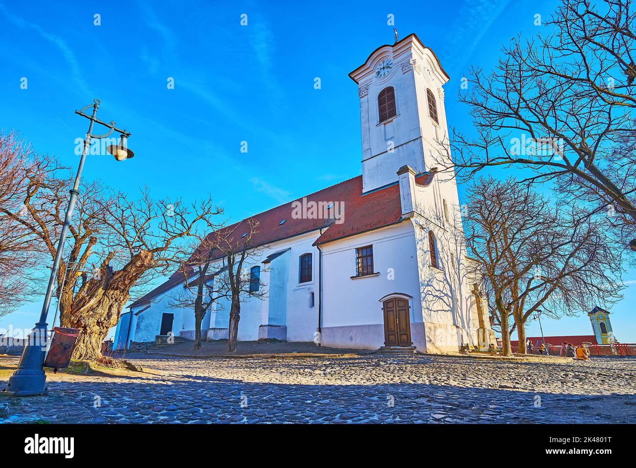 The medieval whitewashed clocktower of St John the Baptist Church on ...