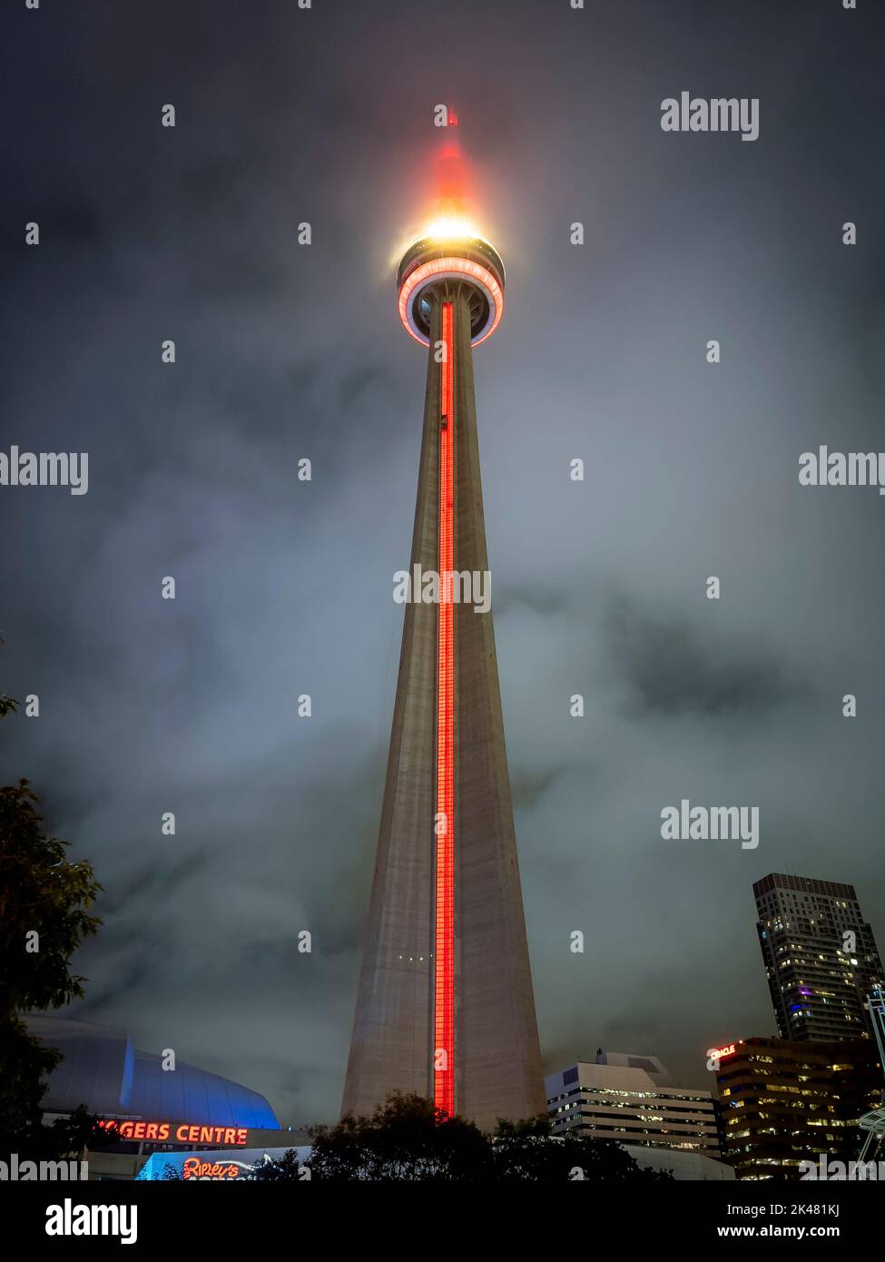 Spire of the CN Tower in Toronto, Ontario, covered with stormy clouds ...