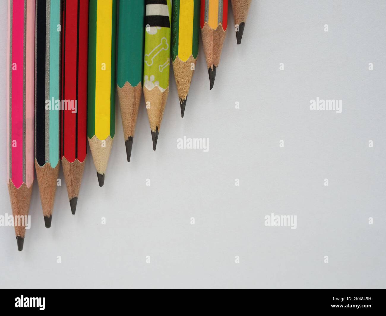 A pencil arranged in a row on a white background Stock Photo - Alamy
