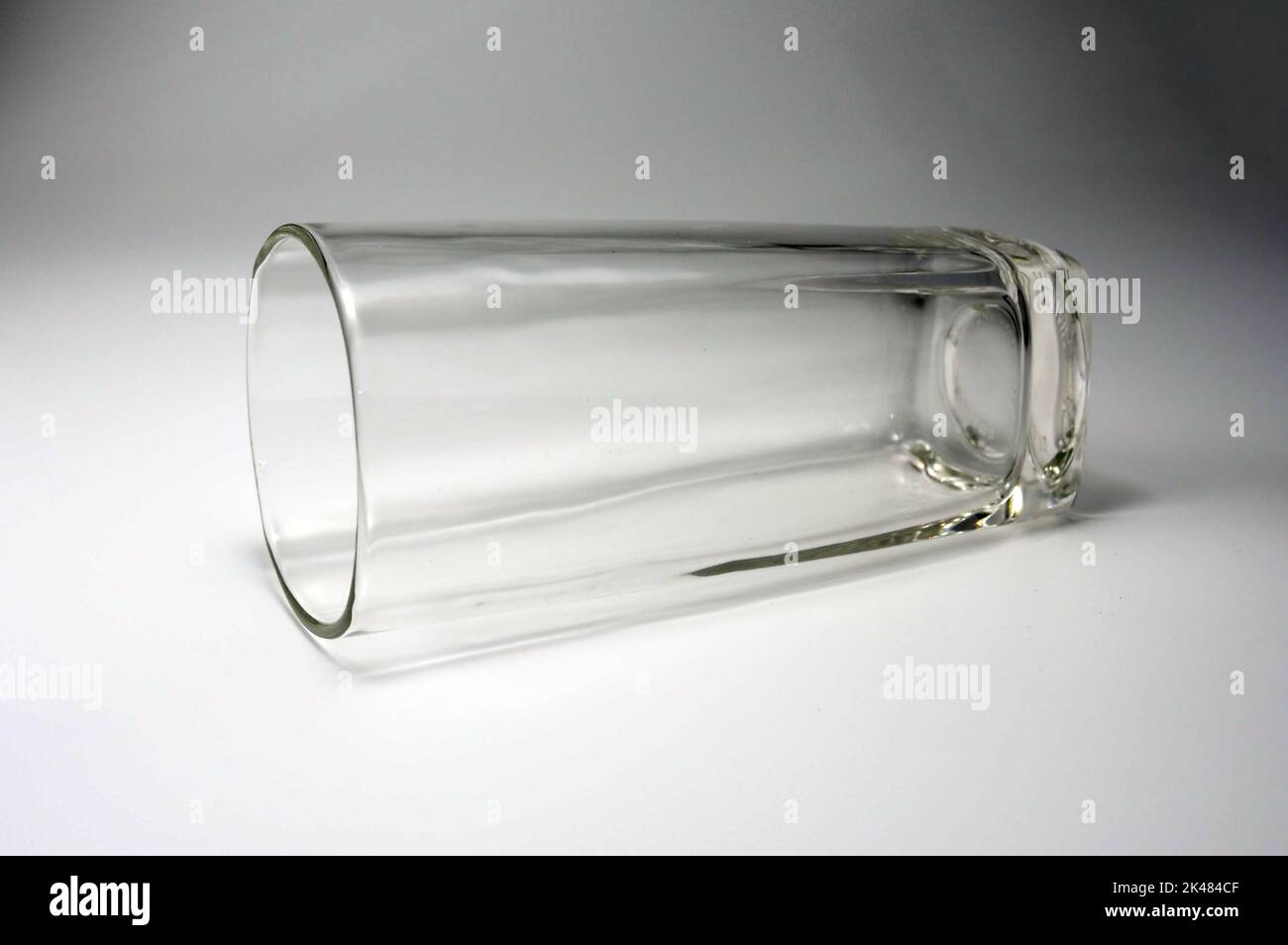 Empty glass Lying on a white background Stock Photo - Alamy
