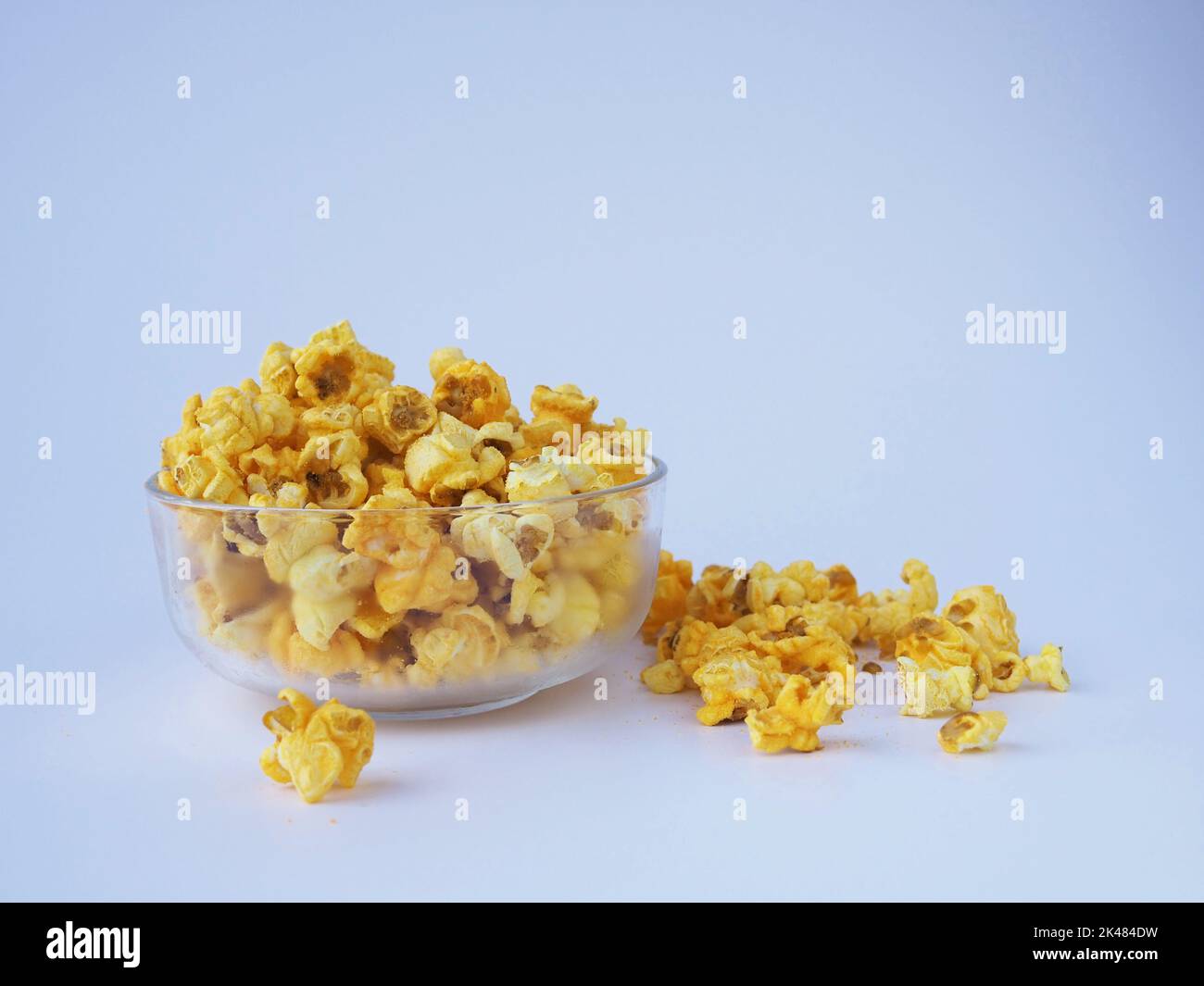 Popcorn in bowl on white background Stock Photo - Alamy