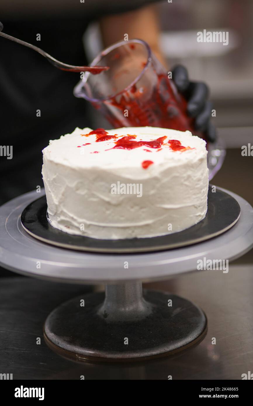 Bleeding monster cake with knife on cake stand Stock Photo - Alamy