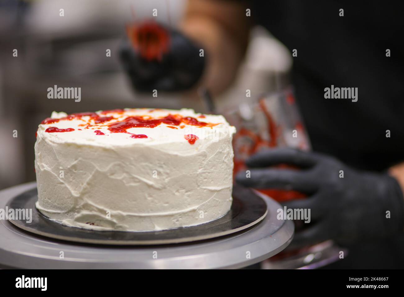 Bleeding monster cake with knife on cake stand Stock Photo - Alamy