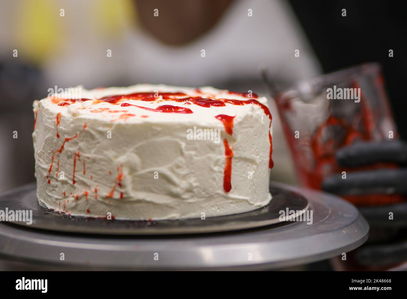Bleeding monster cake with knife on cake stand Stock Photo - Alamy