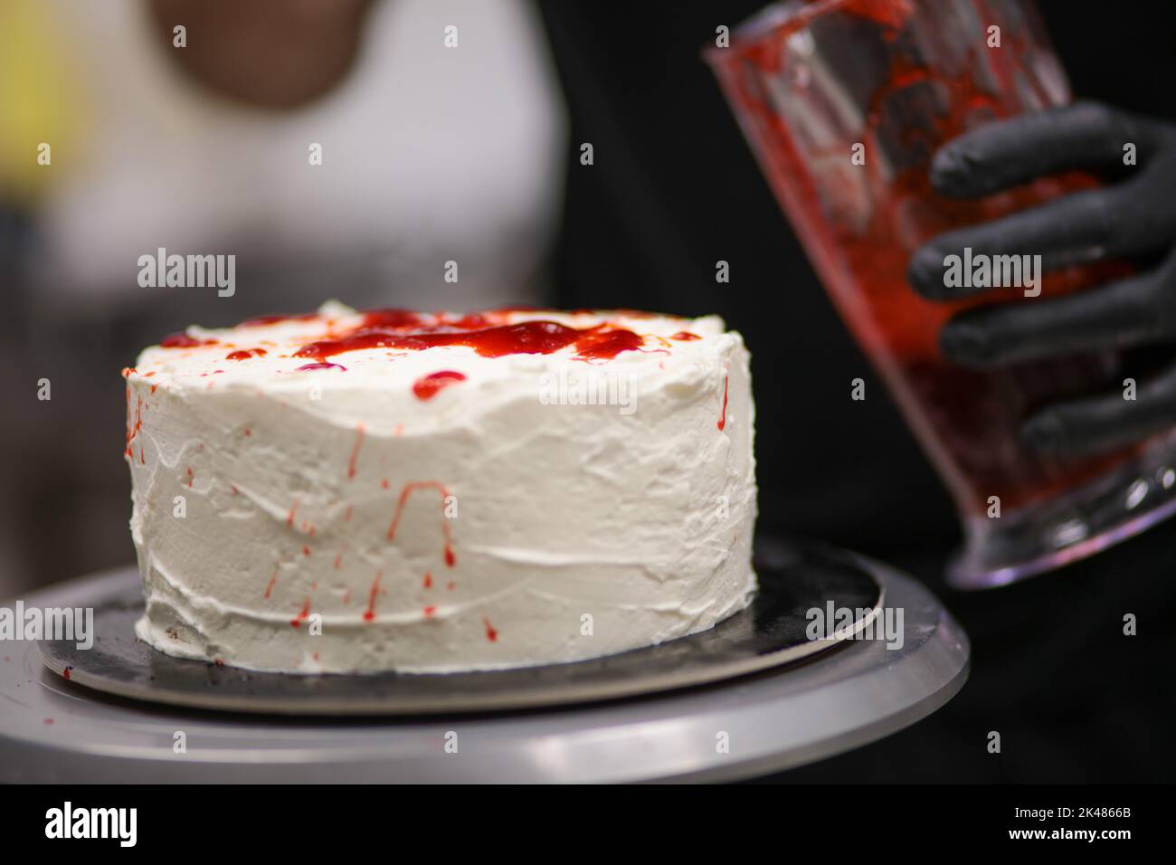 Bleeding monster cake with knife on cake stand Stock Photo - Alamy