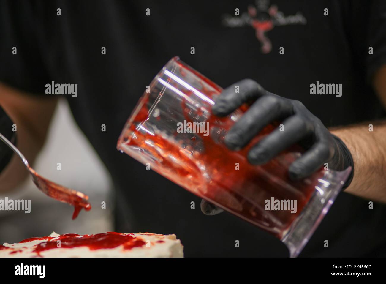 Bleeding monster cake with knife on cake stand Stock Photo - Alamy
