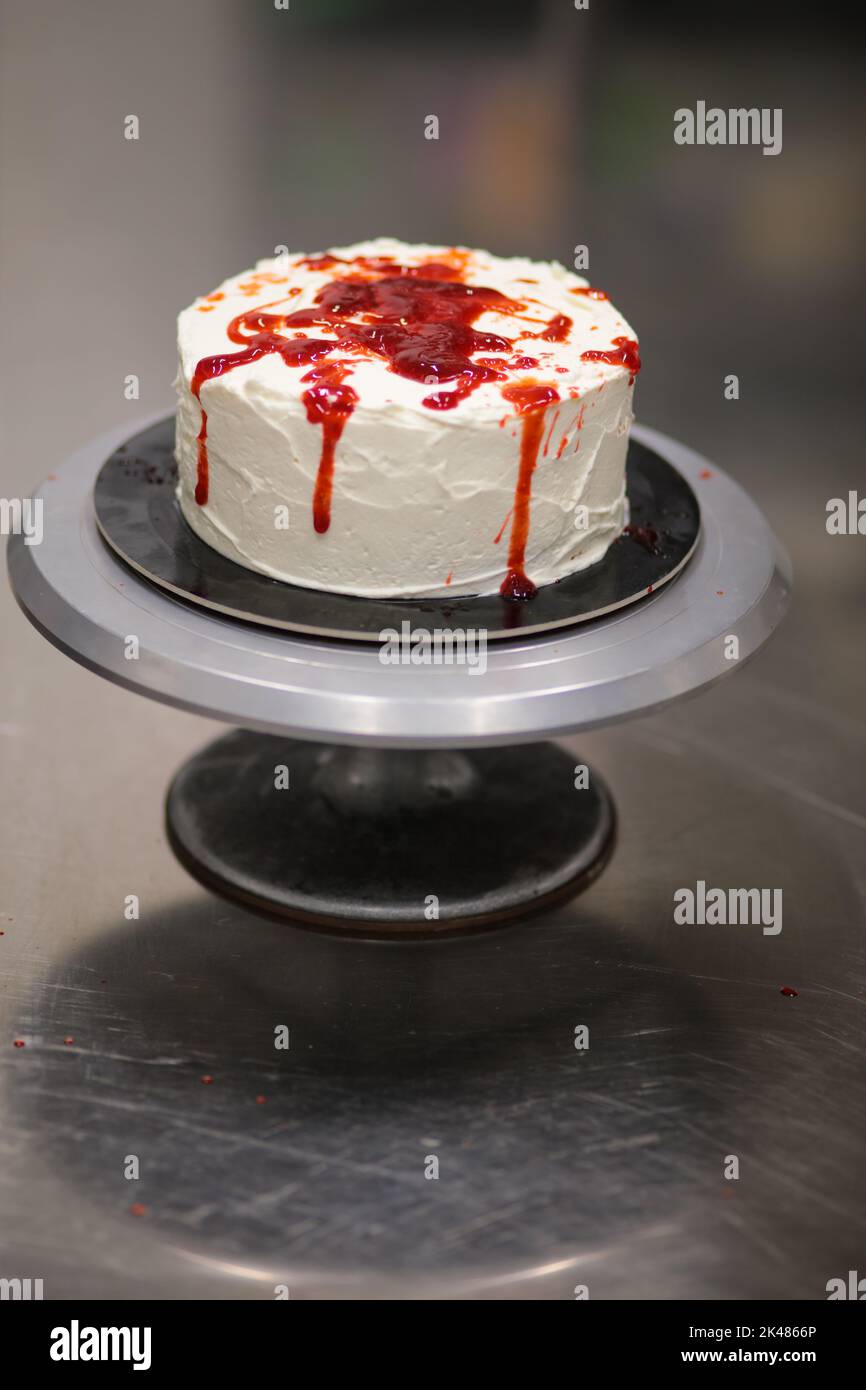 Bleeding monster cake with knife on cake stand Stock Photo - Alamy