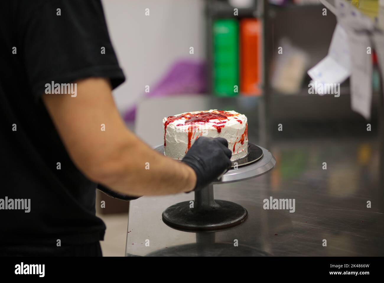 Bleeding monster cake with knife on cake stand Stock Photo - Alamy