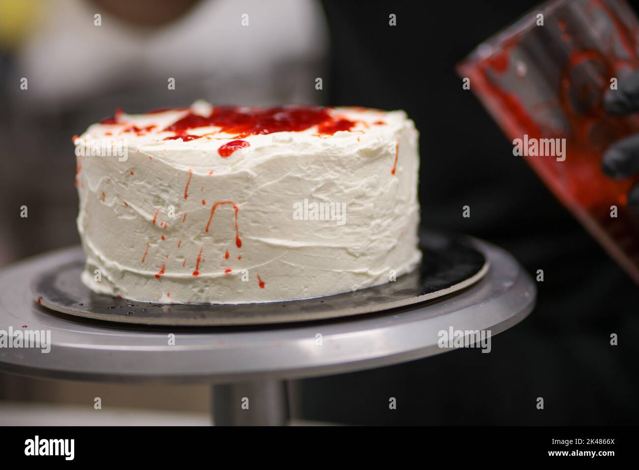 Bleeding monster cake with knife on cake stand Stock Photo - Alamy